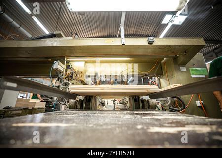 A manufacturing facility with a modern woodworking machine processing ...