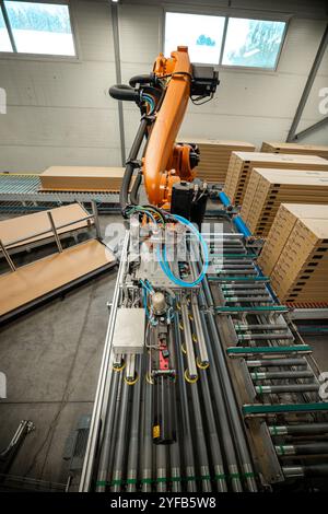 A robotic arm in a woodworking factory, equipped with suction ...