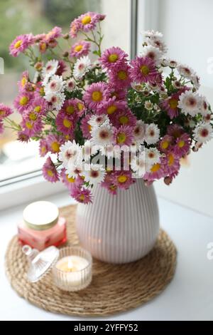 Burning candles near bouquet of flowers at night Stock Photo - Alamy