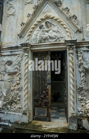 Elaborate stone carvings at a tomb of the cemetery next to the Church ...