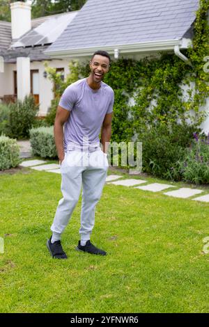 Young Man in Casual Outfit Stands Confidently Against a Bright Yellow ...