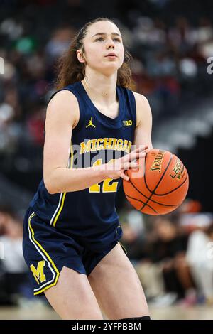 Michigan guard Syla Swords (12) shoots over UCLA guard Kiki Rice (1 ...