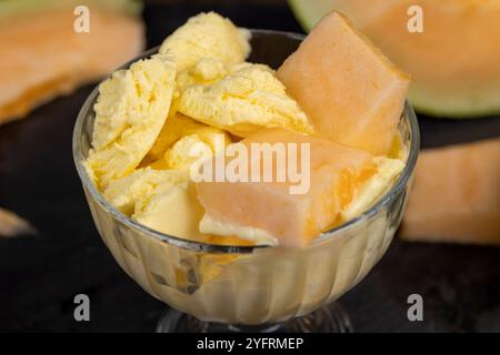 melon flavored ice cream and melon cut into pieces close up, sweet ...