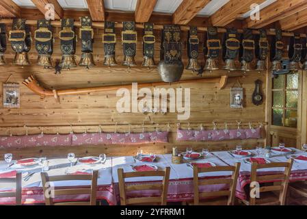 Cow bells displayed in restaurant of mountain farm. Vosges, Alsace ...