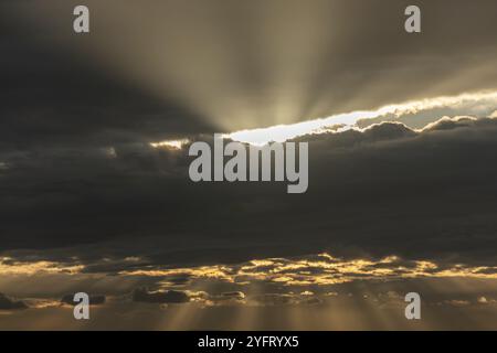 Beams of light of sun's rays through clouds in morning. Alsace, France ...