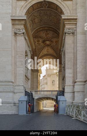 Vatican Swiss guards, one of them, left, holding up his right arm and ...