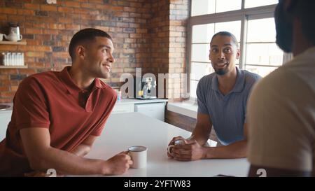 Multi-Cultural Businessmen Taking Coffee Break In Kitchen Area Of ...