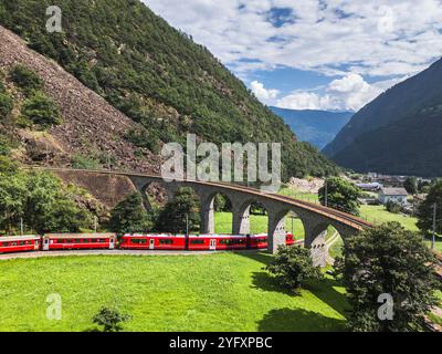 Aerial of a Train crossing the Brusio spiral viaduct, Unesco world ...