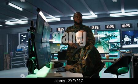Soldier doing tasks in military base, doing surveillance with digital ...