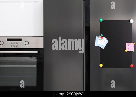 Magnetic board and notes on refrigerator in kitchen Stock Photo - Alamy