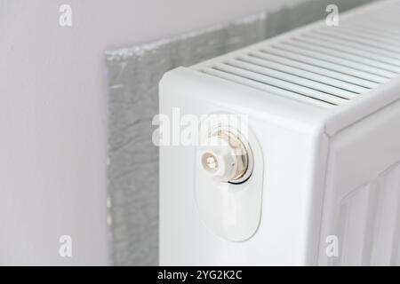Thermal insulation panel positioned behind radiator to reflect heat ...