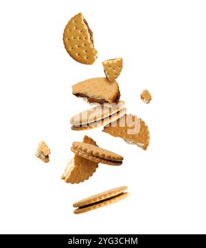 Tasty broken sandwich cookies in air on white background Stock Photo ...