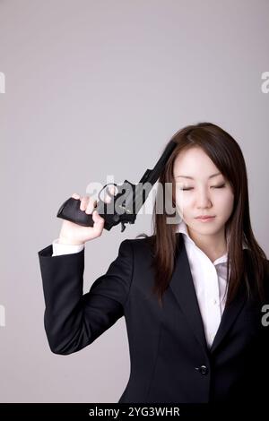 Woman with revolver-type gun Stock Photo - Alamy