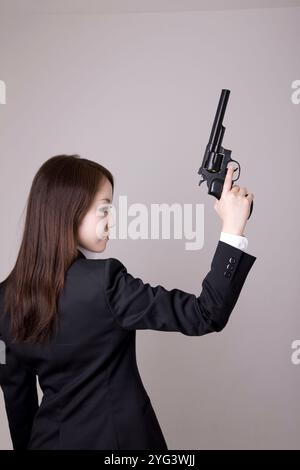Woman with revolver-type gun Stock Photo - Alamy