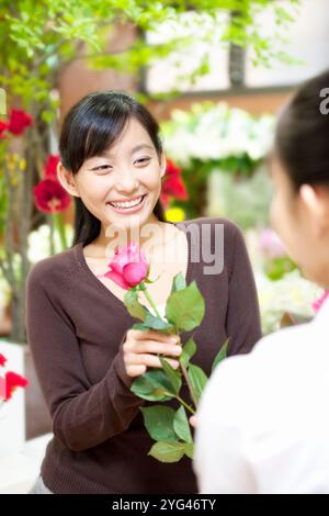 young woman receiving rose in bar of hotel Stock Photo - Alamy