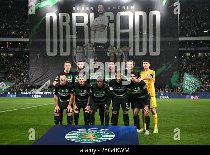 Sporting Lisbon players line up in front of a banner wishing thanks to ...