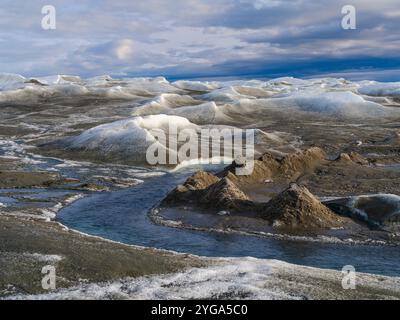 Drainage system on the surface of the ice sheet. Brown sediment on the ...