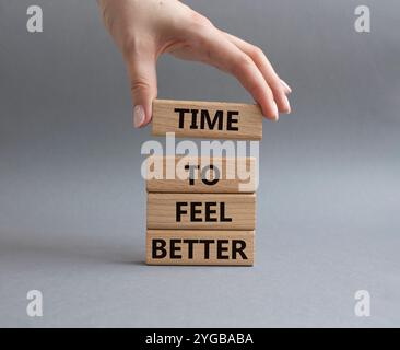 Time to feel better symbol. Wooden blocks with words Time to feel ...