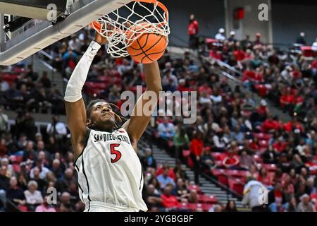 San Diego State forward Pharaoh Compton (5) shoots in front of Utah State forward Karson Templin ...