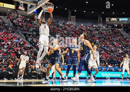 San Diego State forward Pharaoh Compton (5) shoots in front of Utah State forward Karson Templin ...