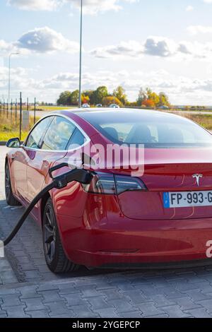 Red full electric Tesla Model 3 has super fast charging Stock Photo - Alamy