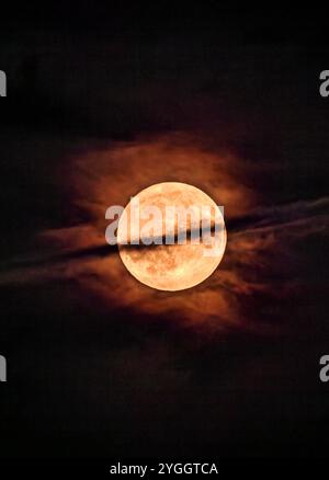 The full moon, known as the strawberry moon in June, passes over the ...