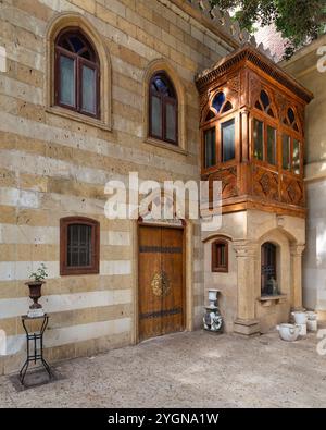 A Mamluk style stone facade featuring a richly decorated wooden door ...