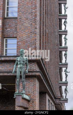 Male bronze sculpture on the corner of the brick facade of the Brahms ...