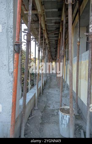 A construction site corridor supported by metal scaffolding, showing ...