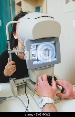 Optometrist, woman on microscope and glasses for calibration, exam and ...