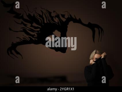 Shadow of monster on wall and scared little girl in room Stock Photo ...