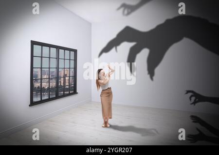 Woman scared by monstrous hands reaching for her. Creepy shadows in ...
