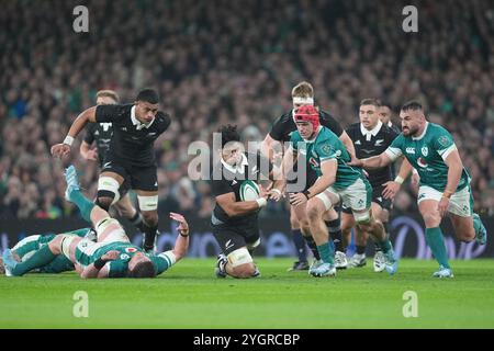 Wallace Sititi, centre, of New Zealand runs at the defence during their ...