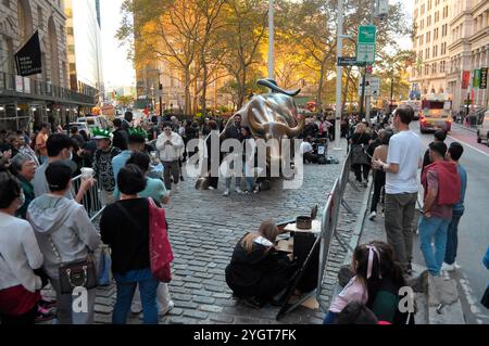 People take photos by the "Charging Bull" statue in the Financial District in Manhattan, New ...