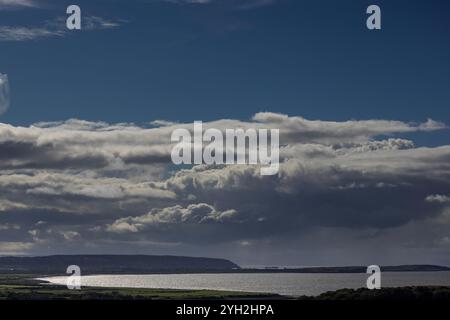 Squally weather over the Severn estuary with cumulus clouds and blue ...