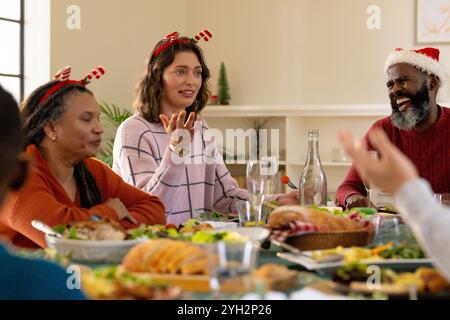 Multiracial family laughing and enjoying dinner at home Stock Photo - Alamy