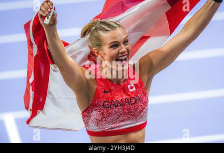 Alysha Newman celebrating her medal with her country's flag at the ...