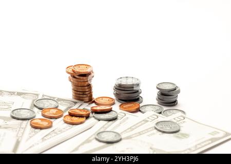US coin and paper currency ascending like a bar graph isolated on white ...