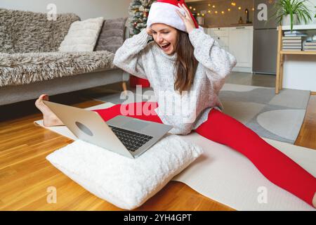Joyful surprised woman looking at laptop screen, sitting at home in ...