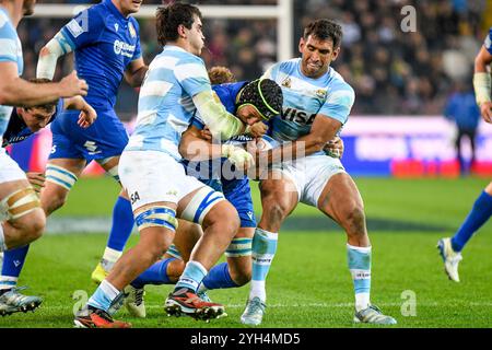 Italy's Juan Ignacio Brex, is tackled by England's Alex Mitchell, right ...