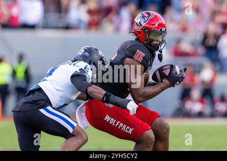 North Carolina State's Justin Joly (7) stretches for the ball with Virginia's Devin Neal (27 ...