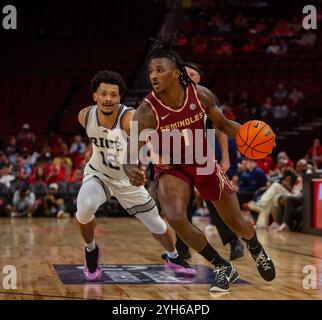 Florida State guard Jamir Watkins (1) fights his way to the basket ...