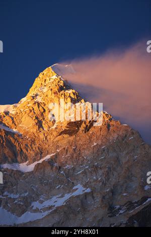 Extreme winds form a banner cloud off the summit of Makalu as sunset ...