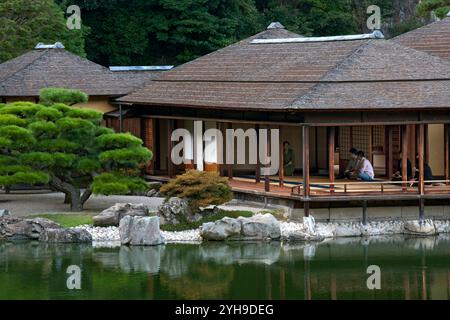 People relaxing at Kikugetsutei tea house at Ritsurin Koen Japanese ...