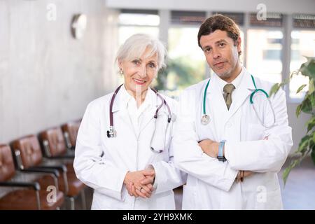 Portrait of positive two doctors at the office of medical clinic Stock ...