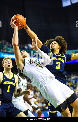 Michigan guard Tre Donaldson (3) goes to the basket past Maryland ...