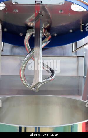 Stand mixer with dough hook mixing flour and water to create bread ...