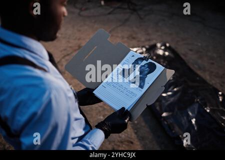 FILE -A forensic police officer work holds a cap at the scene of a ...