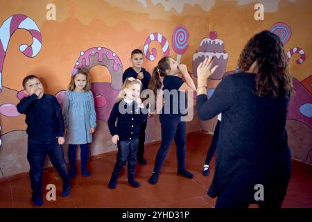 the 5-7 year old children at an acting class with their teacher ...