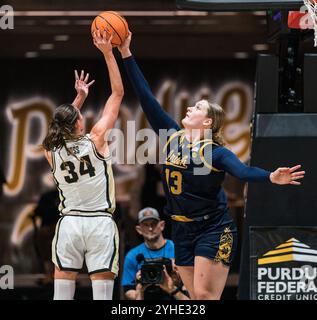 Notre Dame forward Kate Koval, left, shoots over Louisville forward ...